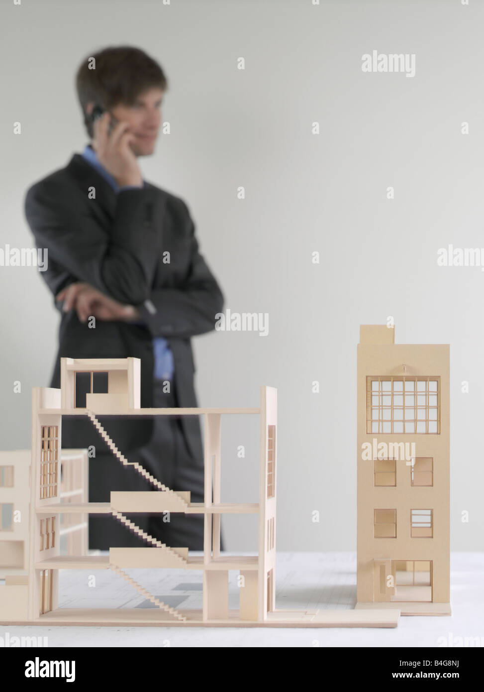 Architectural models and a business man standing in the background ...