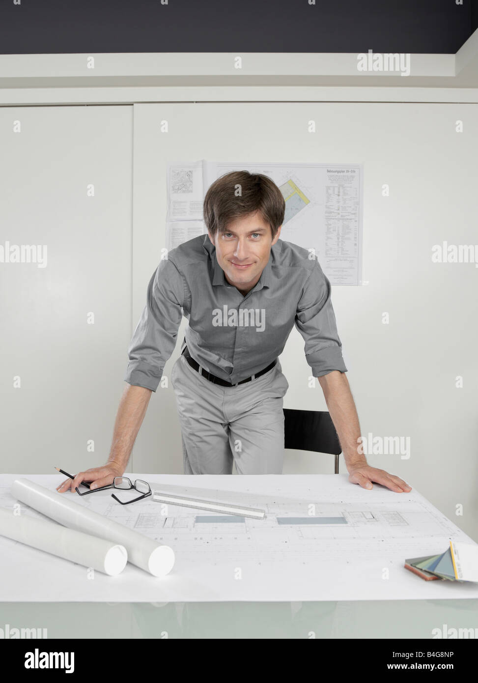 Business a man standing over a desk hi-res stock photography and images ...