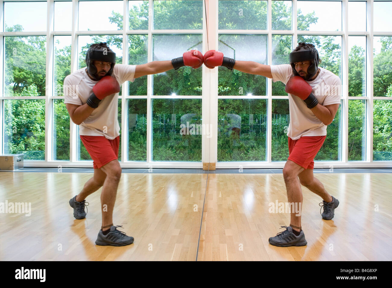 A man boxing his mirrored reflection Stock Photo - Alamy