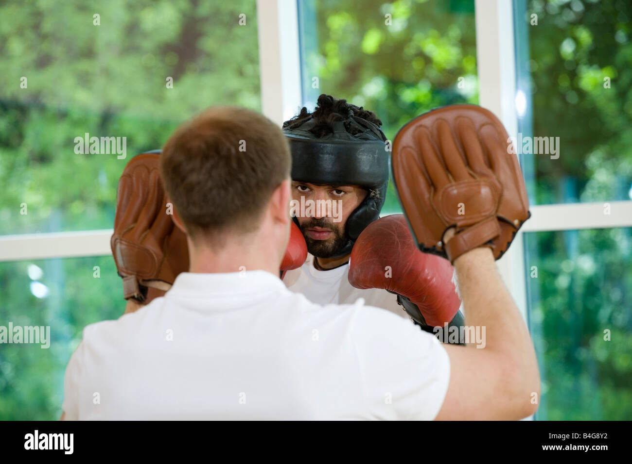 A boxer working with a trainer Stock Photo - Alamy