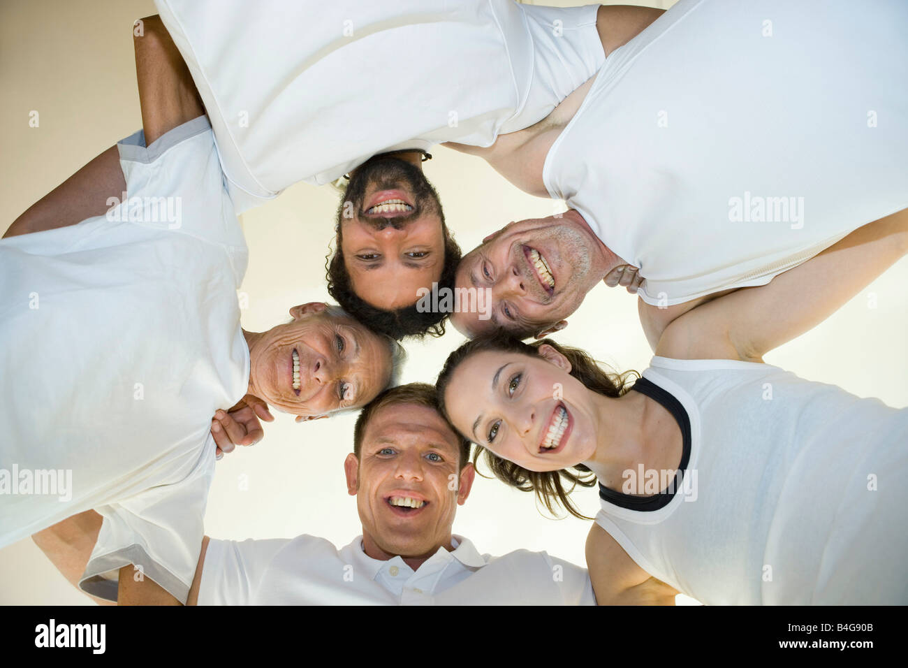 A group of people with their arms around each other, directly below ...