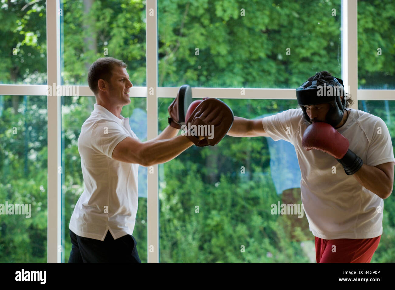 A boxer working with a trainer Stock Photo - Alamy