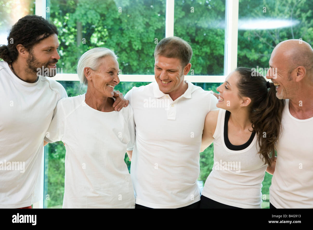A group of people with their arms around each other Stock Photo - Alamy