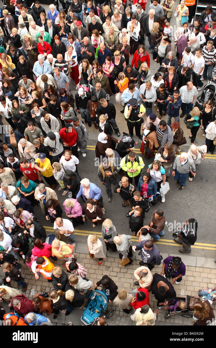Aerial view of a crowd of shoppers pedestrians waiting to enter a new ...