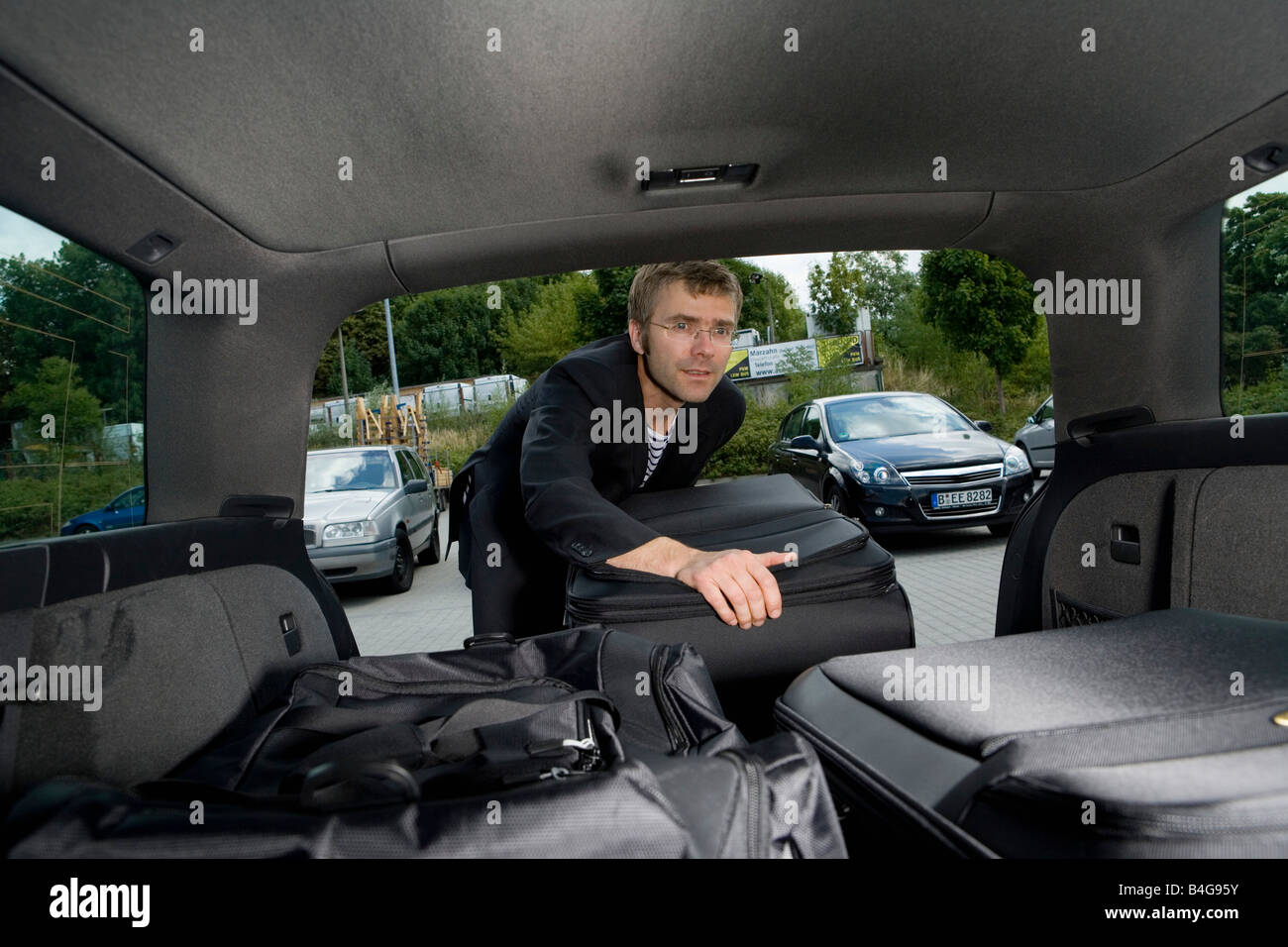Man loading boot of car with luggage hi-res stock photography and ...