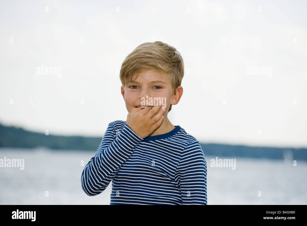 A young boy whistling with his fingers Stock Photo - Alamy
