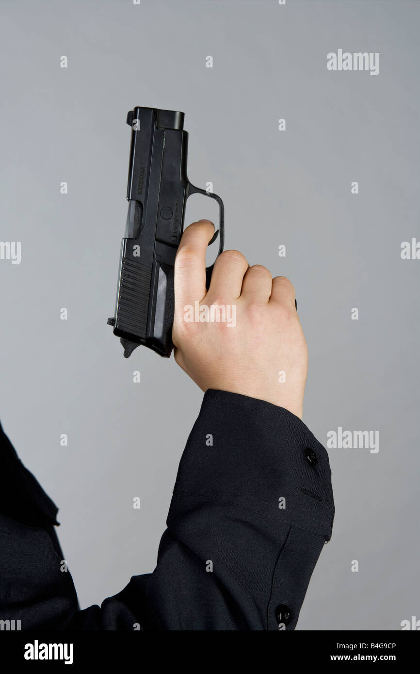 A hand holding a gun Stock Photo - Alamy