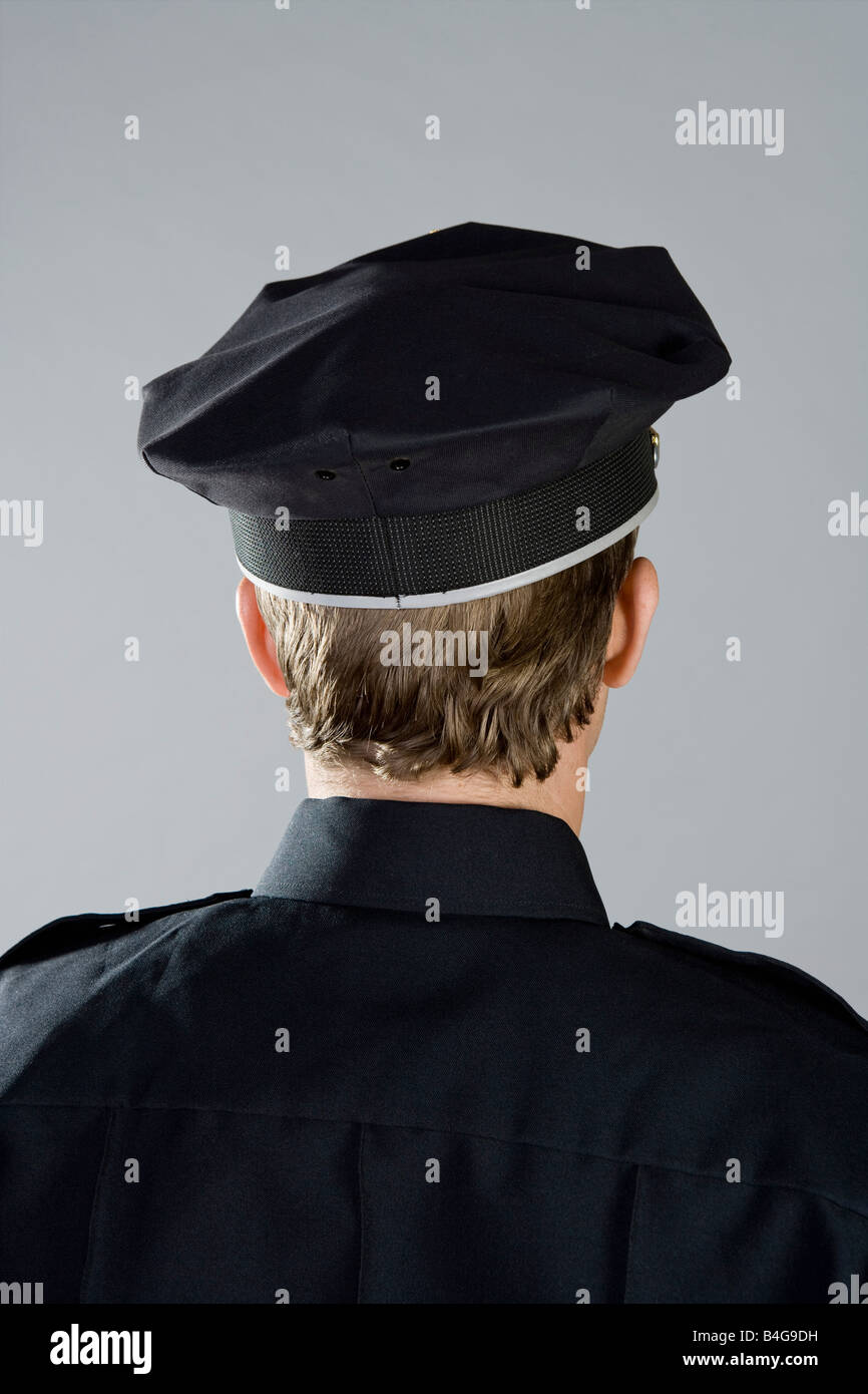 Rear view of a police officer Stock Photo - Alamy