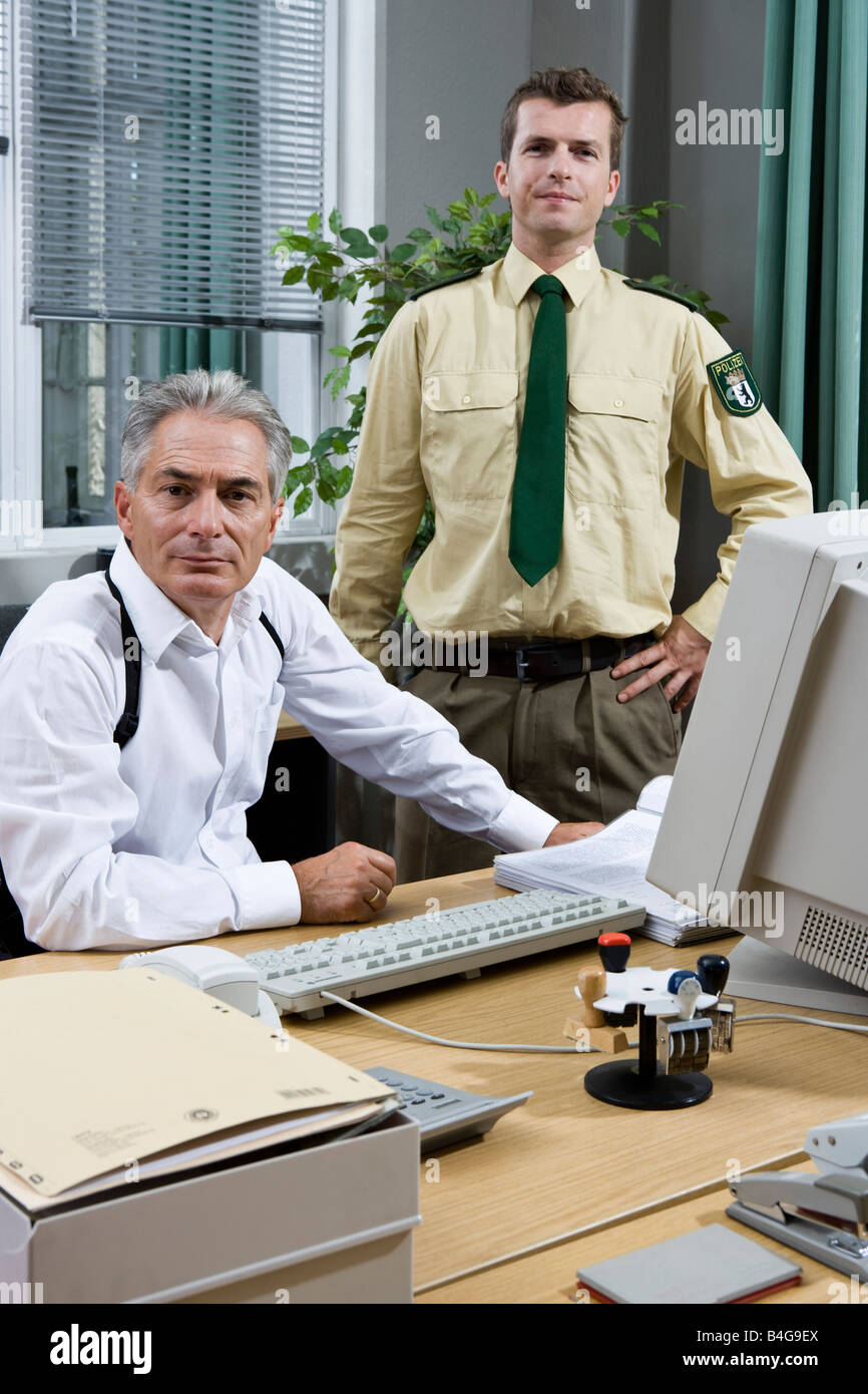 Two police officers working in an office Stock Photo - Alamy