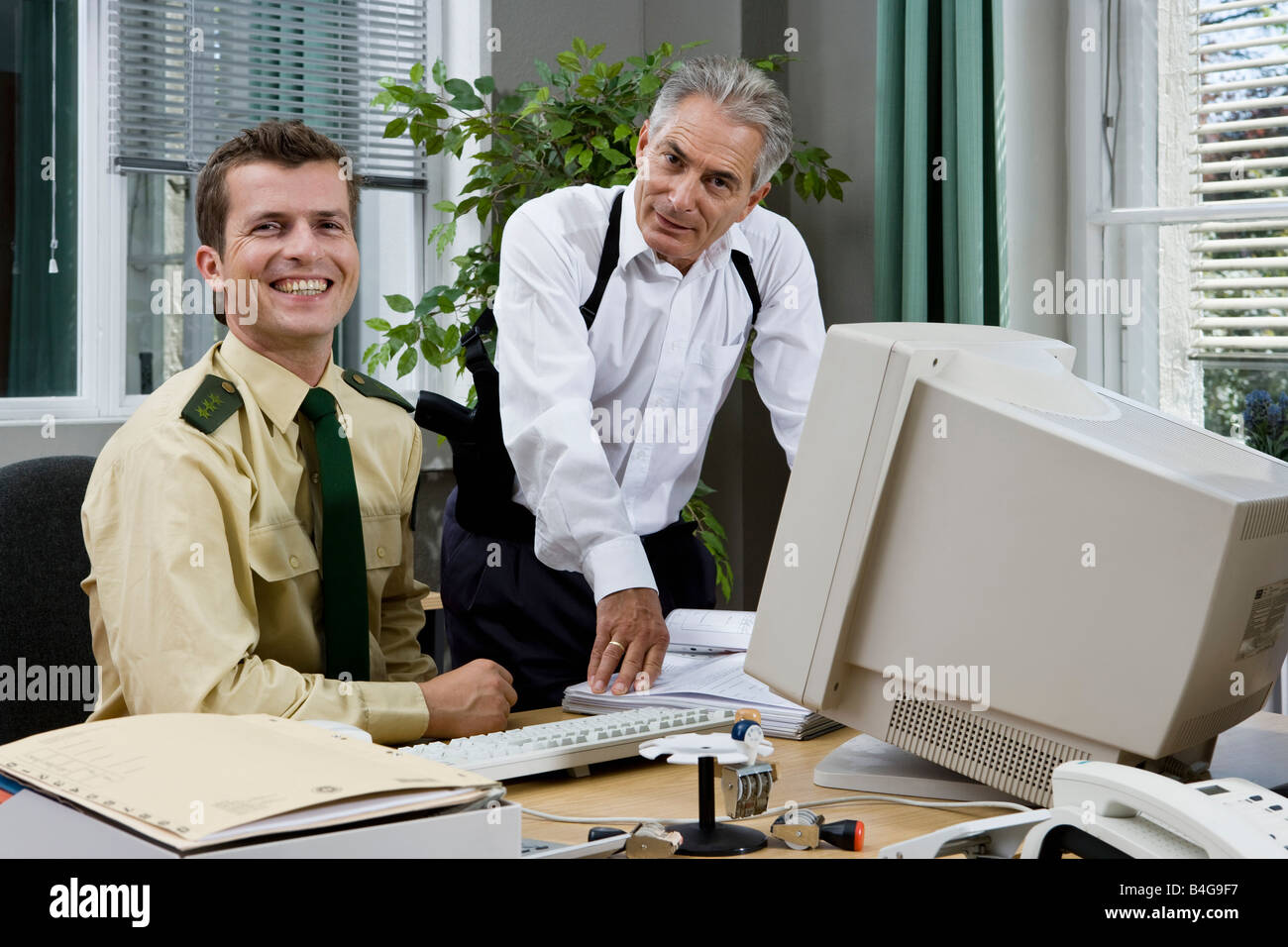 Two police officers working in an office Stock Photo - Alamy