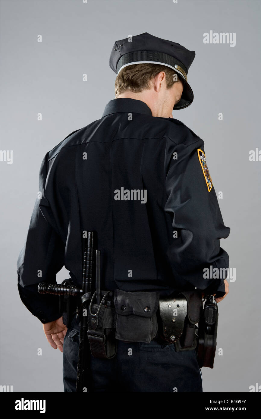 Rear view of a police officer Stock Photo - Alamy