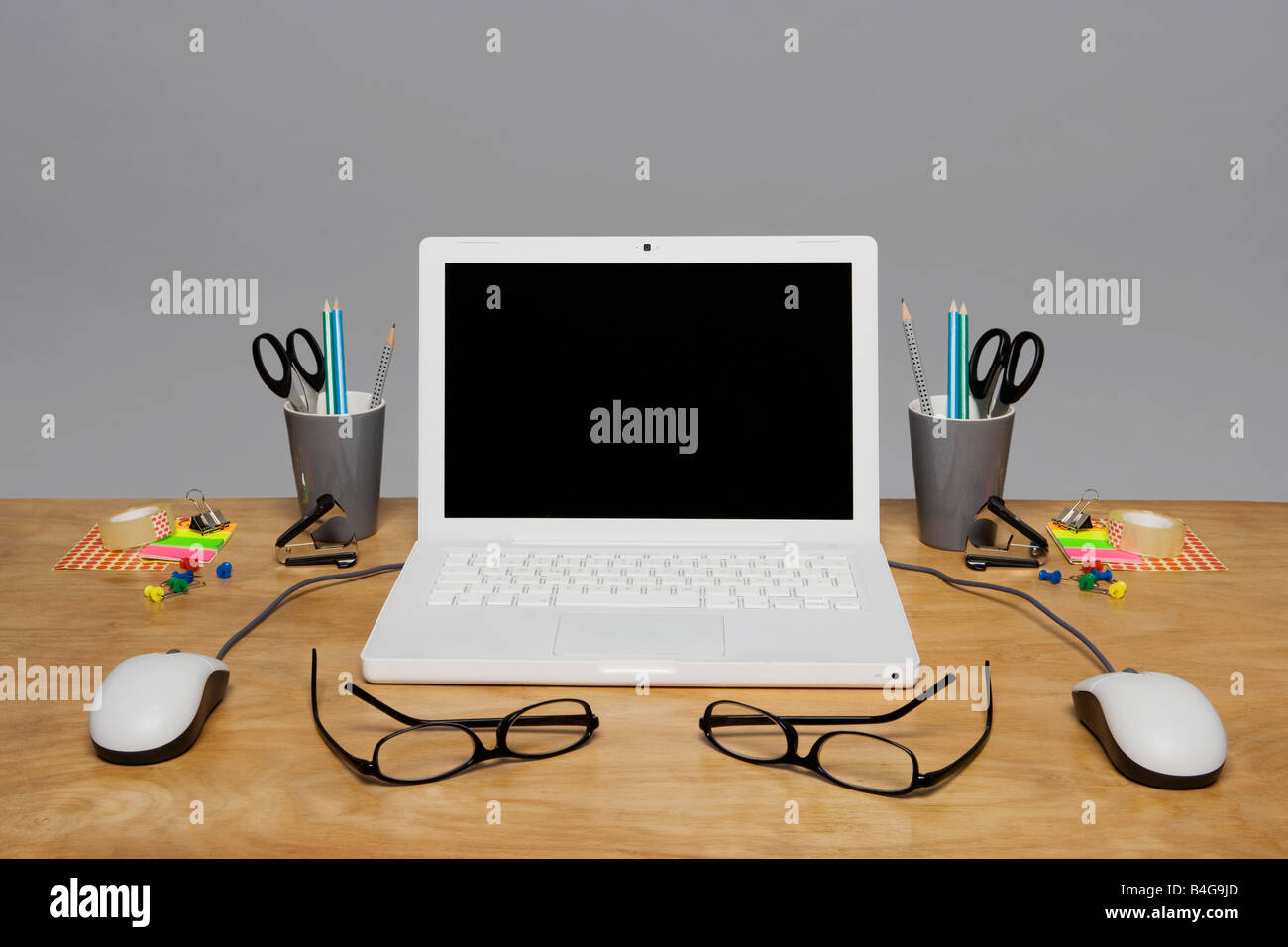 Laptop and stationary arranged on a desk Stock Photo - Alamy