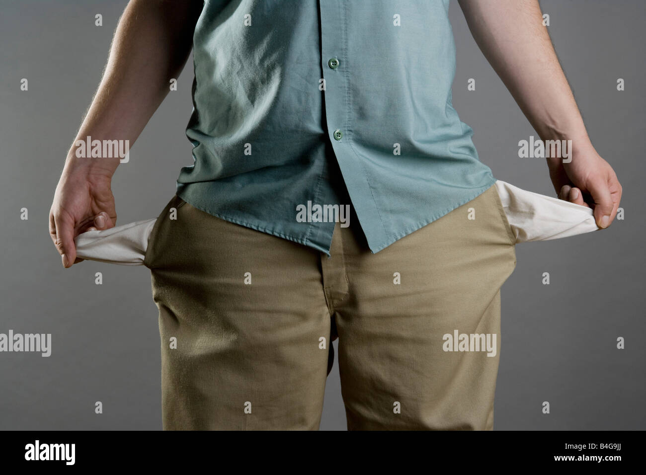 A man showing his empty pockets Stock Photo - Alamy