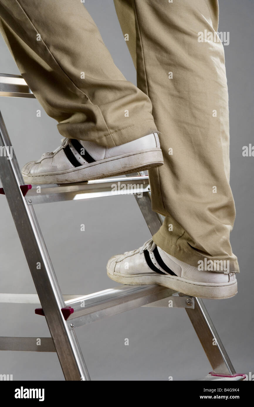 A person climbing a ladder Stock Photo - Alamy