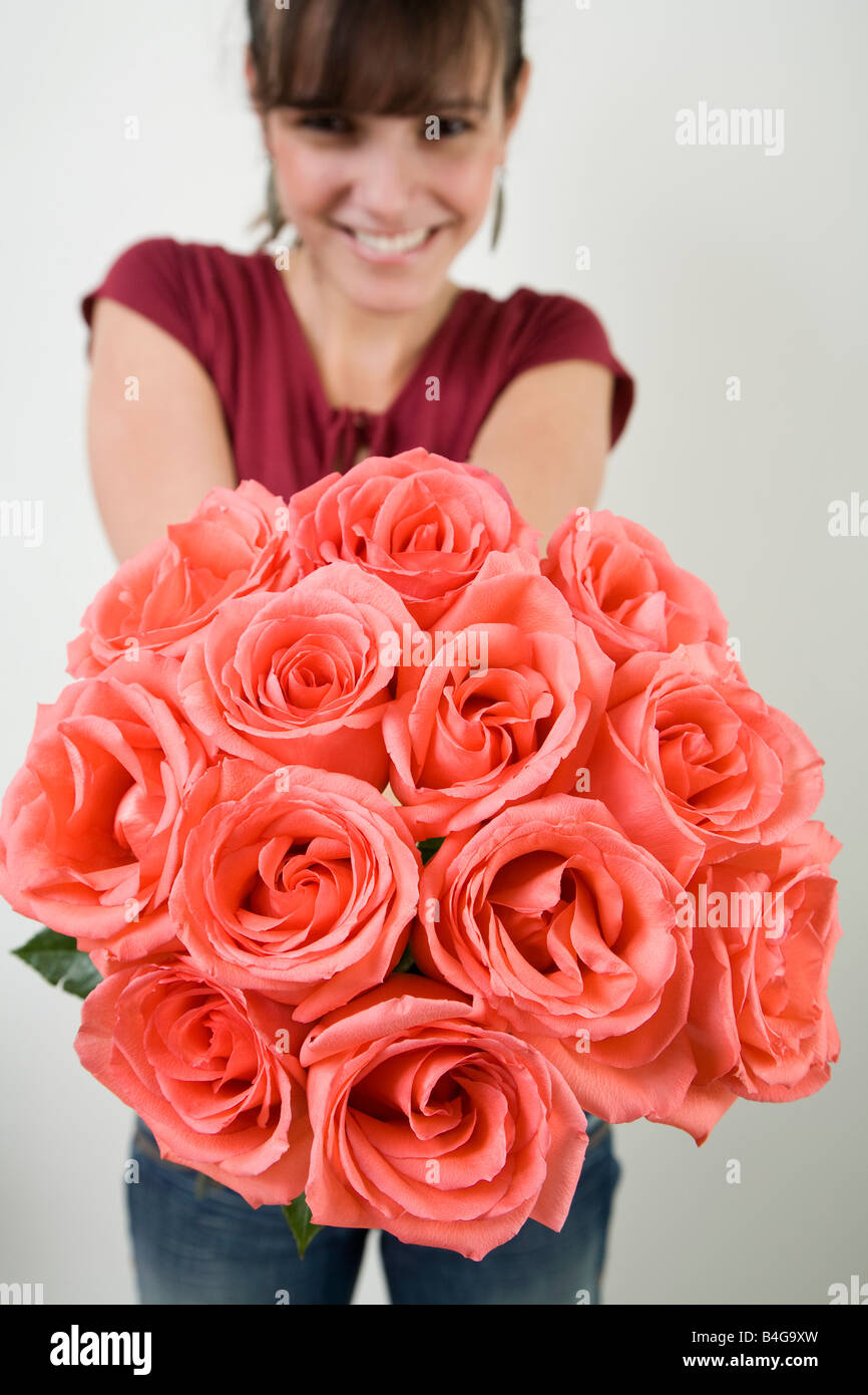 A Latin American woman presenting a bouquet of roses Stock Photo - Alamy