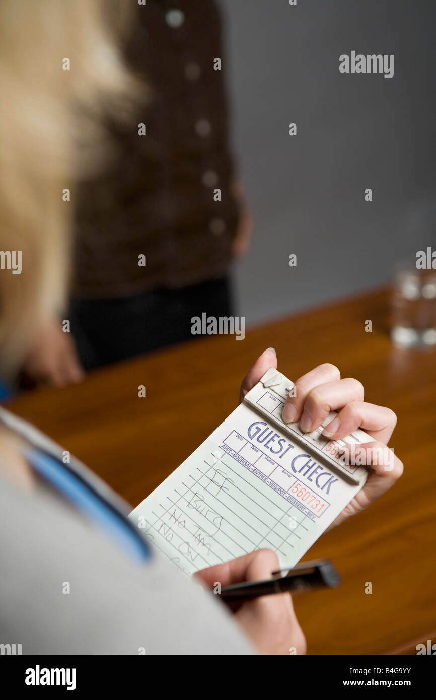 A waitress taking an order, over the shoulder view Stock Photo - Alamy