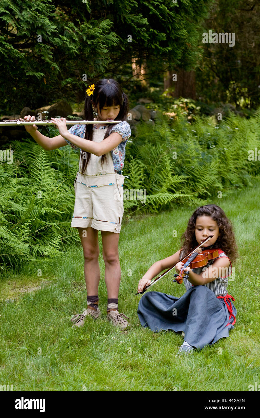 Two children playing instruments hi-res stock photography and images ...