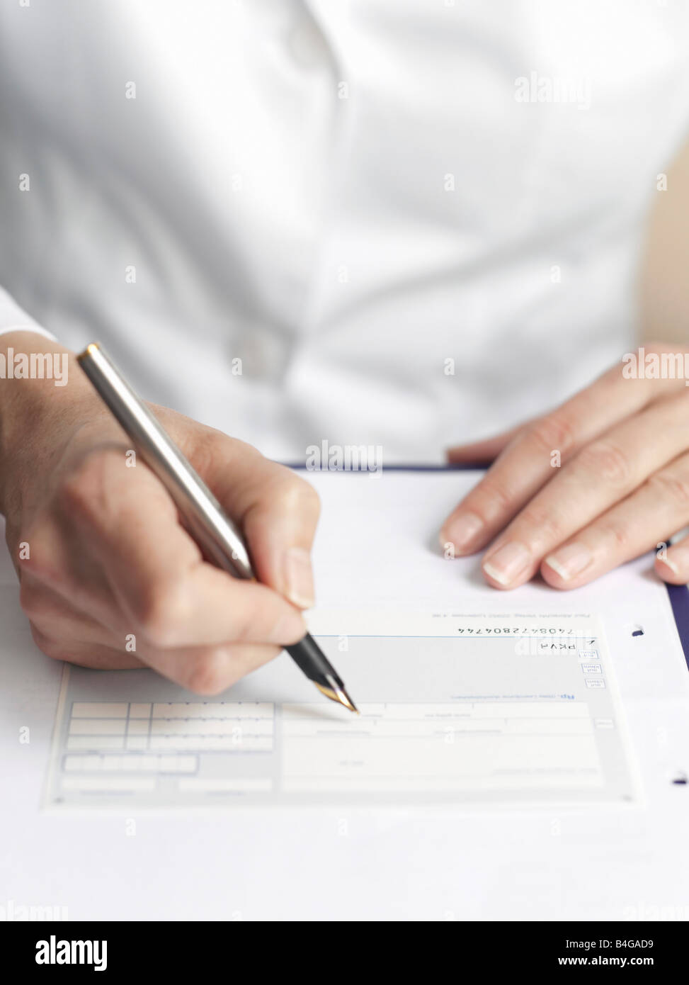 Human hands filling out medical paperwork Stock Photo - Alamy