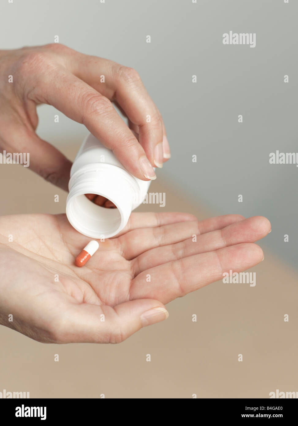 Human hand pouring pill from a pill bottle Stock Photo - Alamy