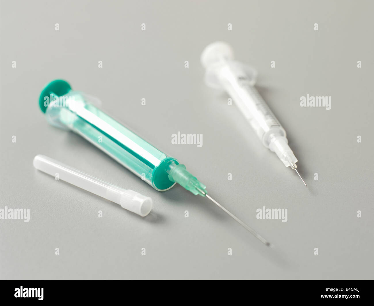 Still Life of two syringes a syringe cap Stock Photo - Alamy