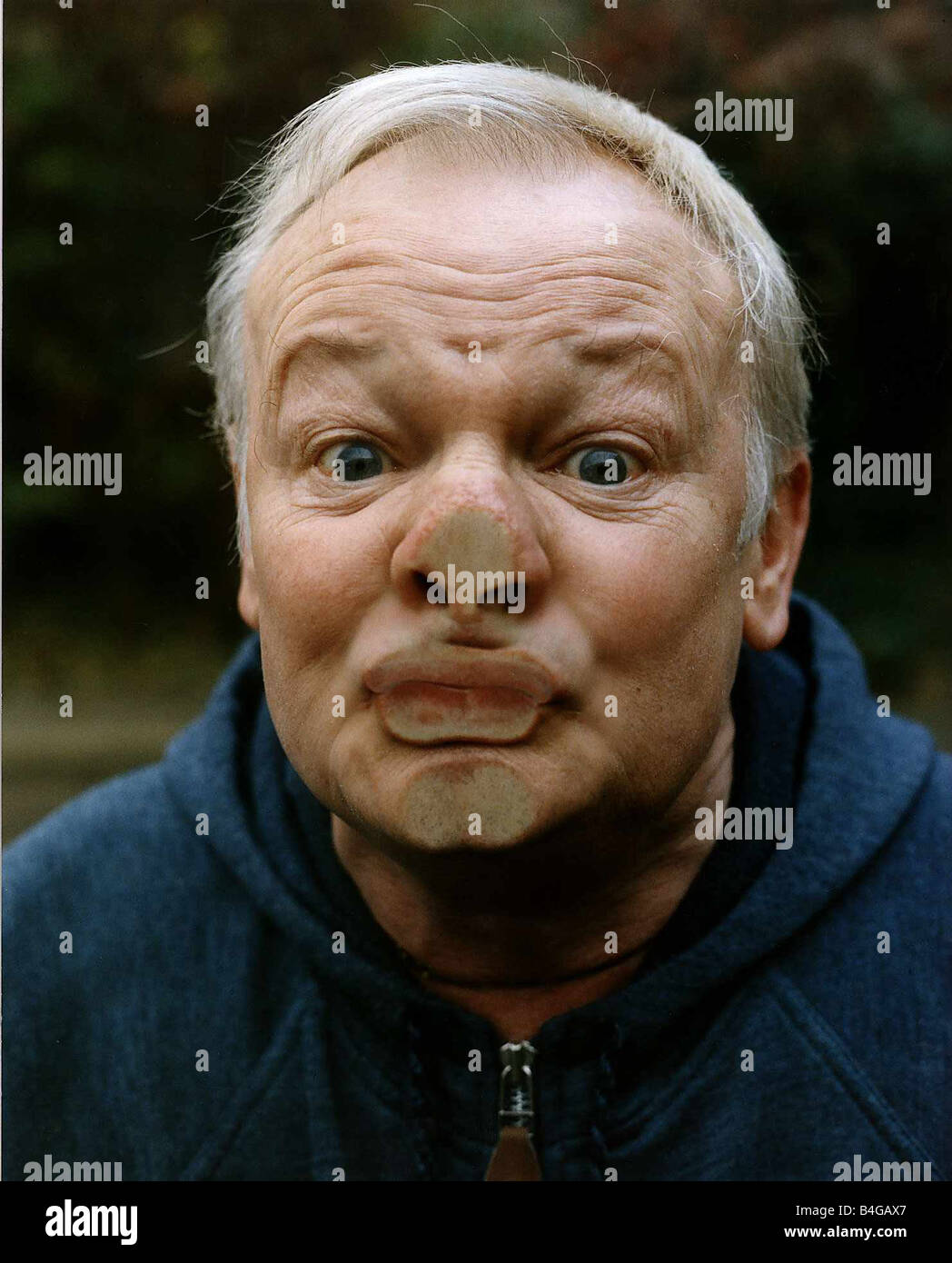 John Inman Comedy Actor presses his face up against a pane of glass to ...