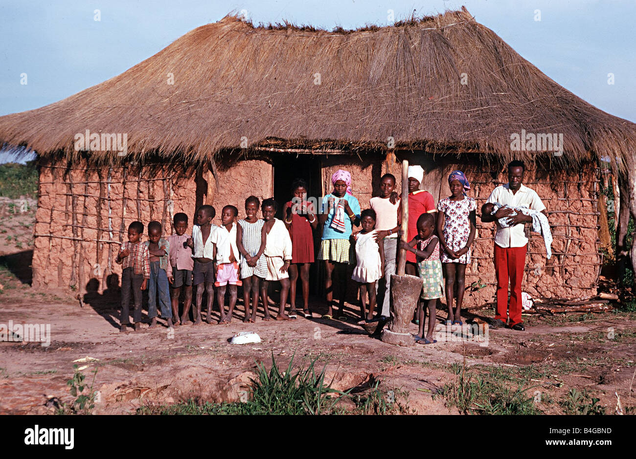 A typical African hut and villagers in Quimbang Africa Stock Photo - Alamy