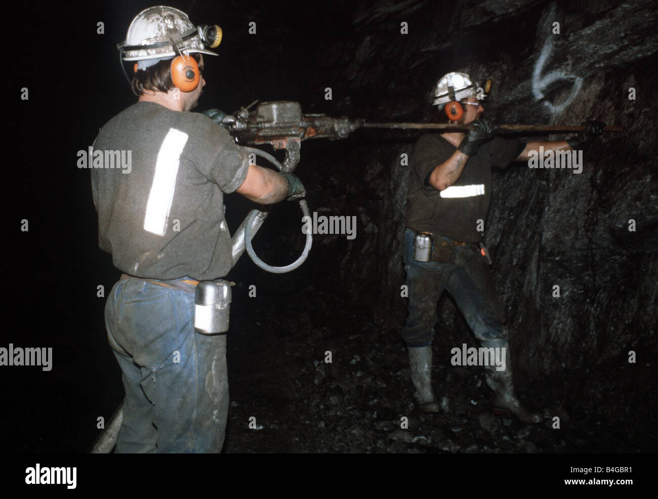 Miners drilling wall of a stope underground broken hill in New South ...