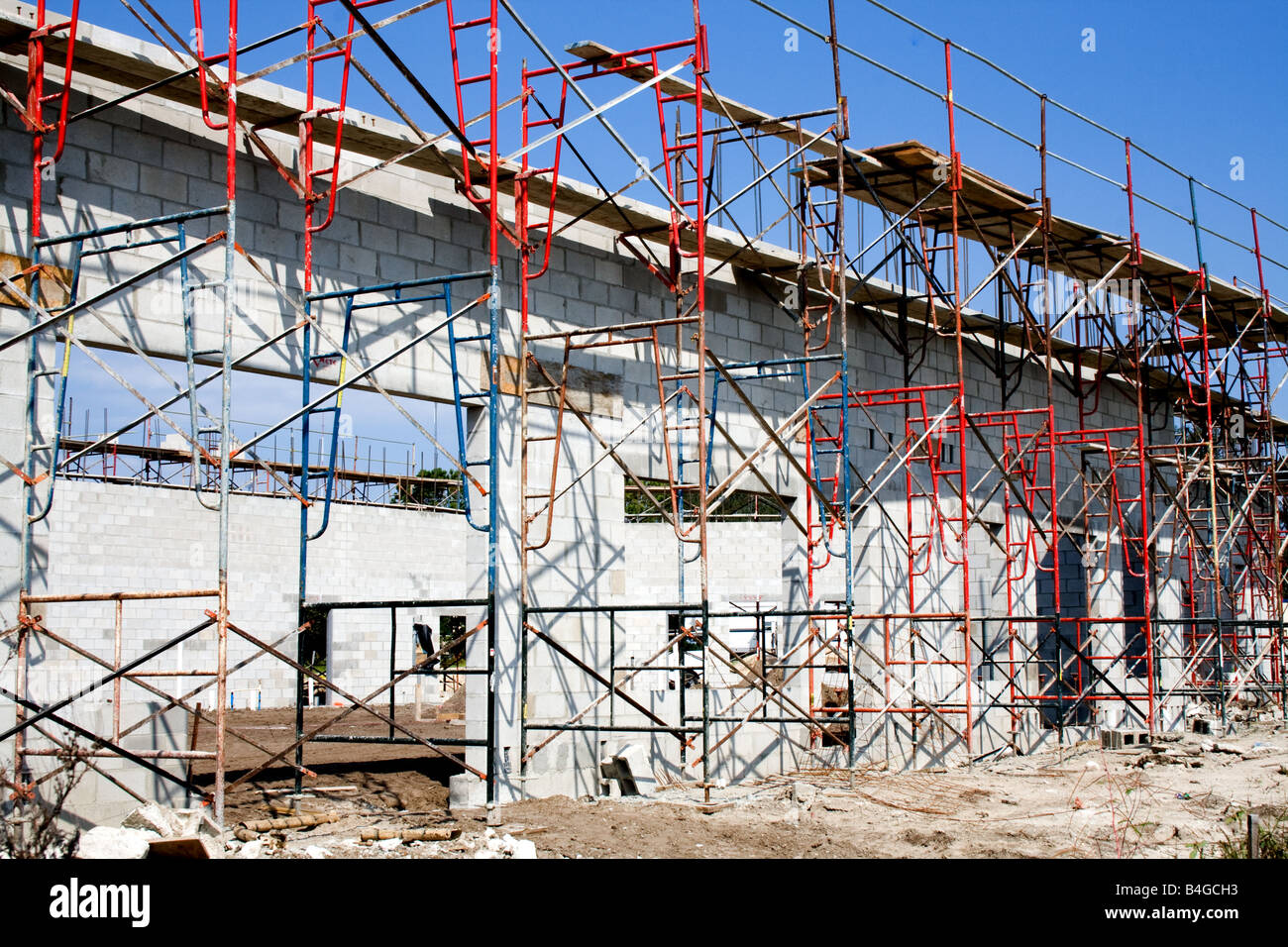 Construction scaffold with wooden walkway for building Stock Photo - Alamy