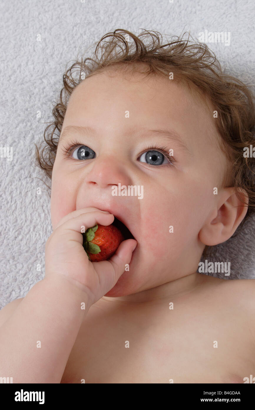 little baby eating strawberry Stock Photo - Alamy