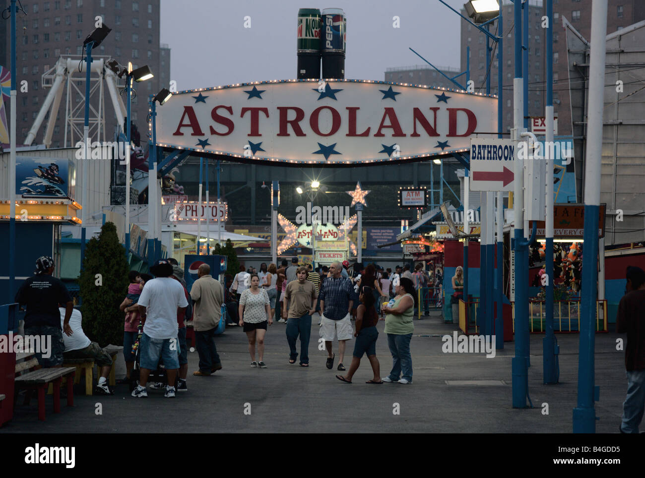People walking through Astroland amusement park at dusk Coney Island ...
