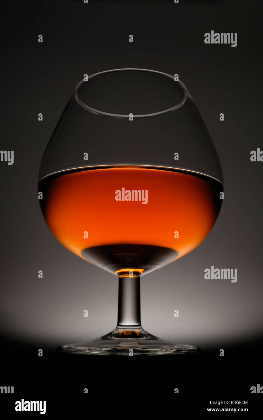 Glass of cognac on a black background Stock Photo - Alamy