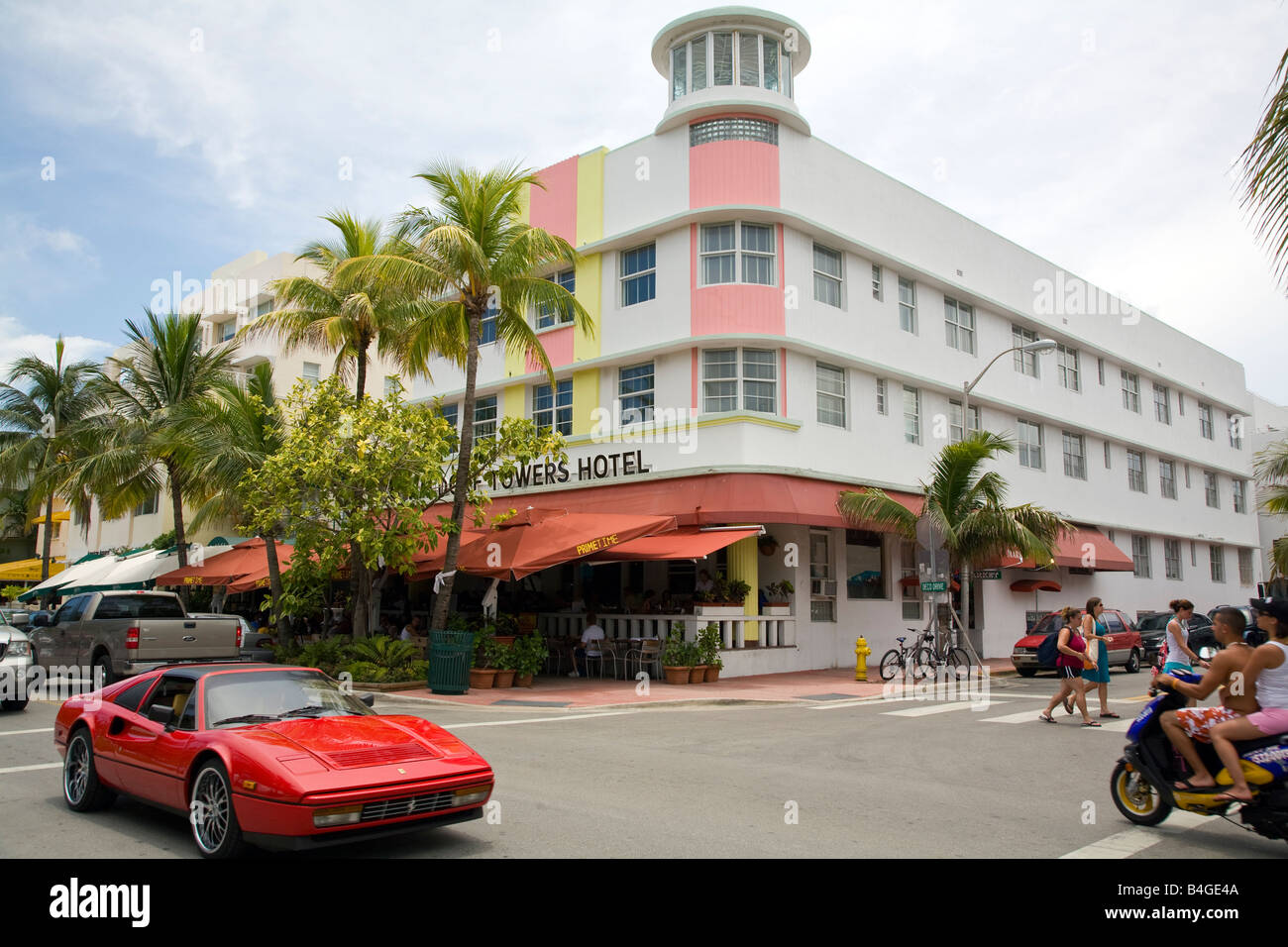 Red Ferrari passing Waldorf Towers Hotel, Ocean Drive, South Beach ...
