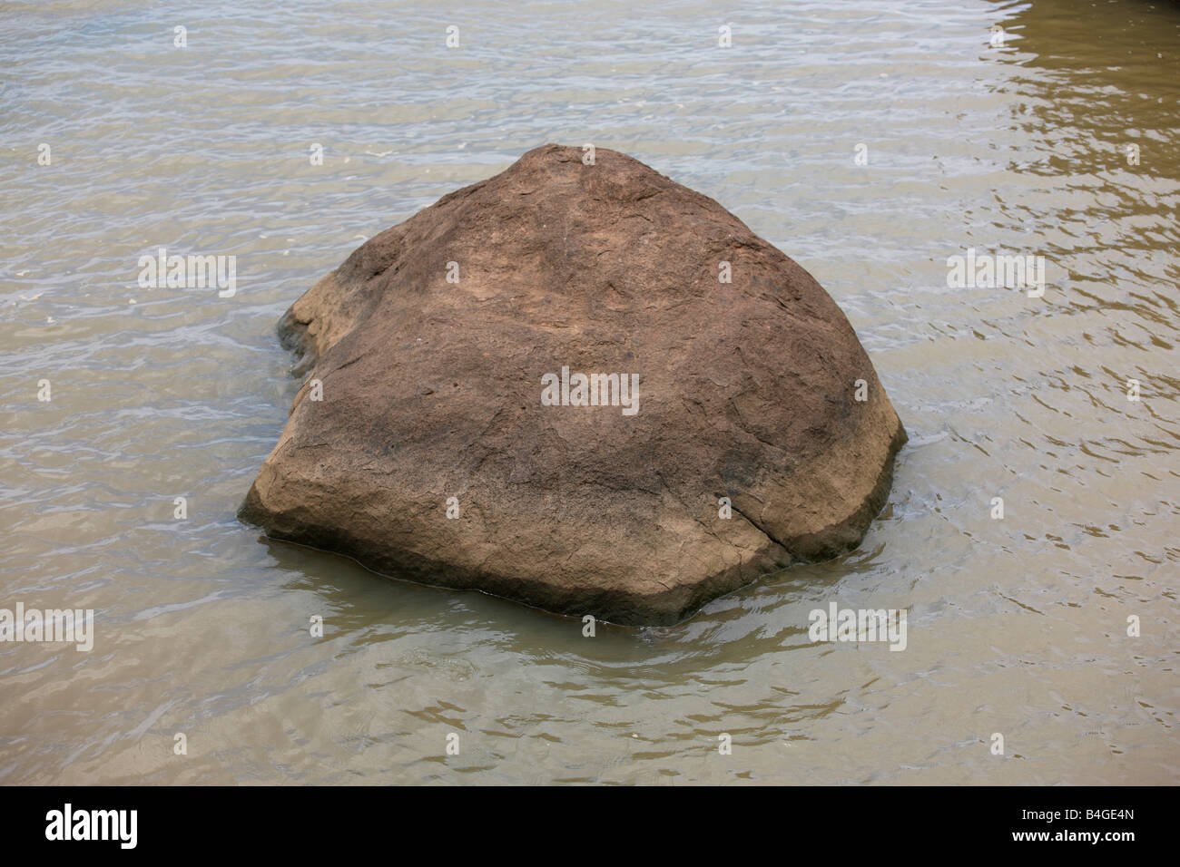 A rock in water Stock Photo - Alamy
