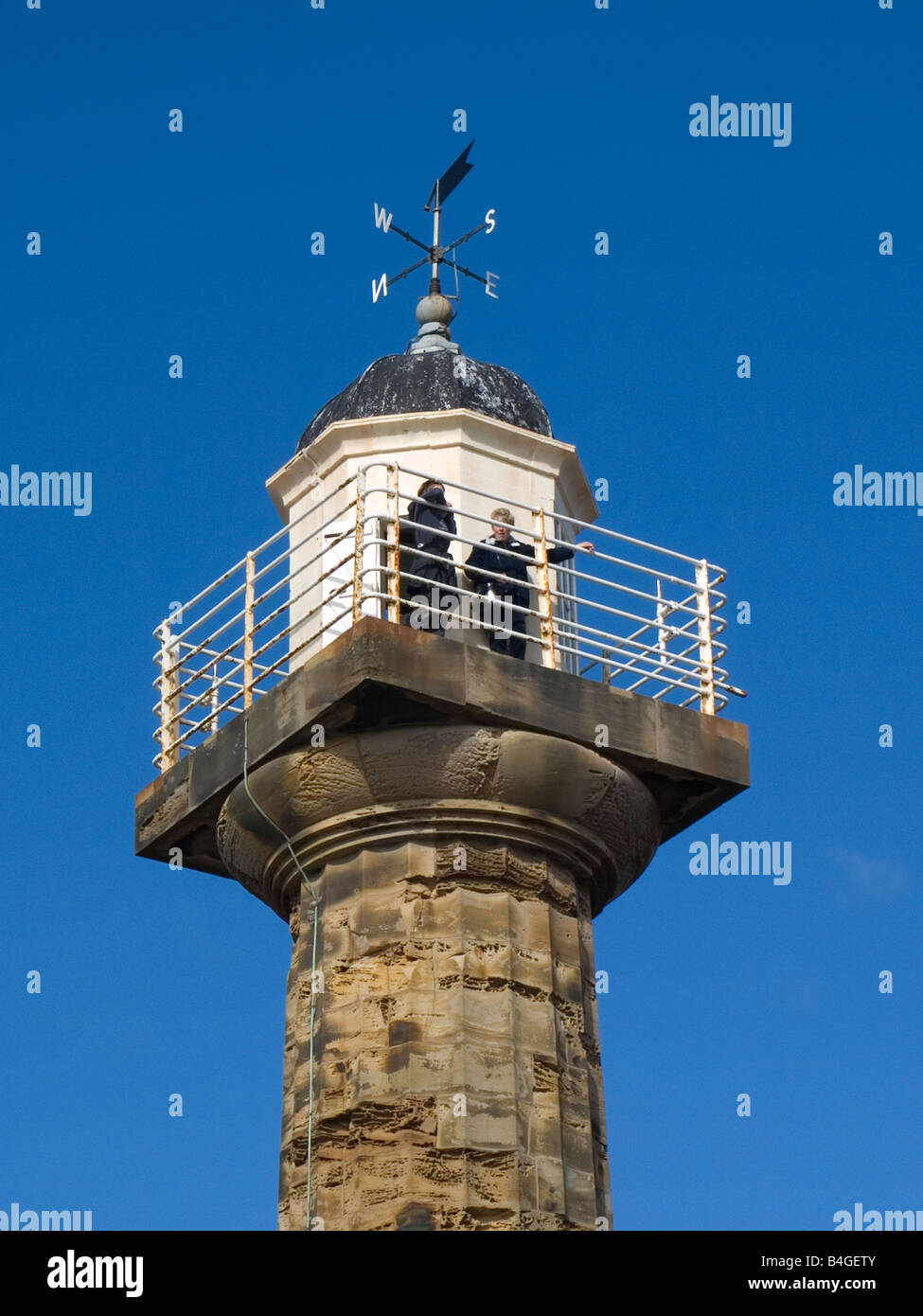 Two visitors on the viewing platform at the top of the West lighthouse ...