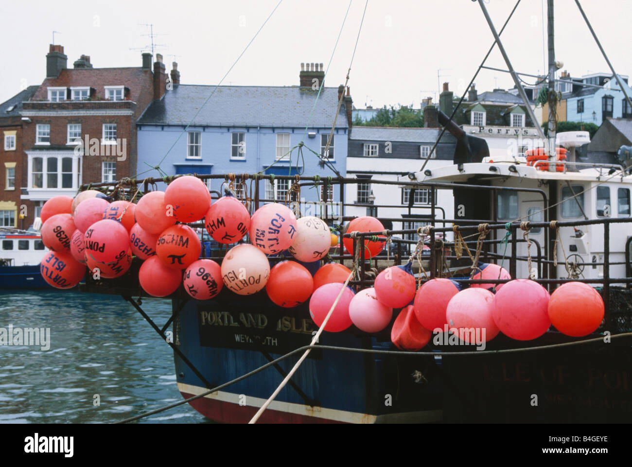 Red floats on fishing boat in Swanage Harbour Dorset Stock Photo - Alamy