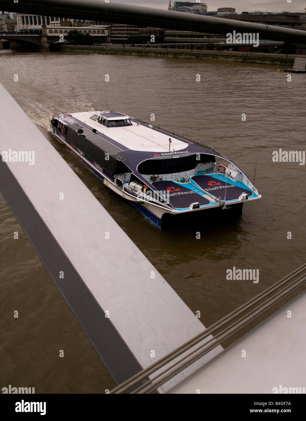 London River Thames Clipper sailing under Millennium bridge Stock Photo ...