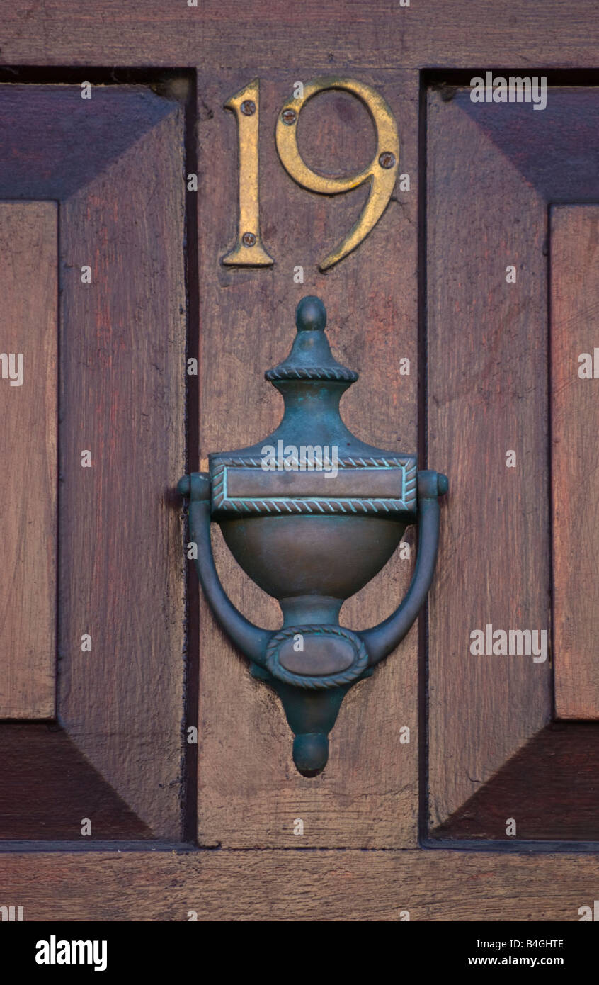 Detail of wooden front door stained dark brown showing number 19 and ...