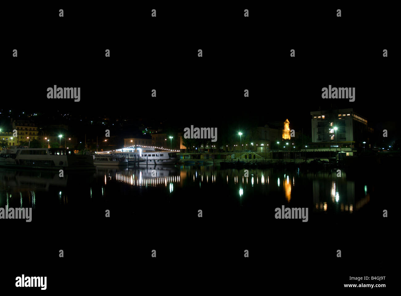 Harbor lights reflecting off the lake in the early hours of the morning ...