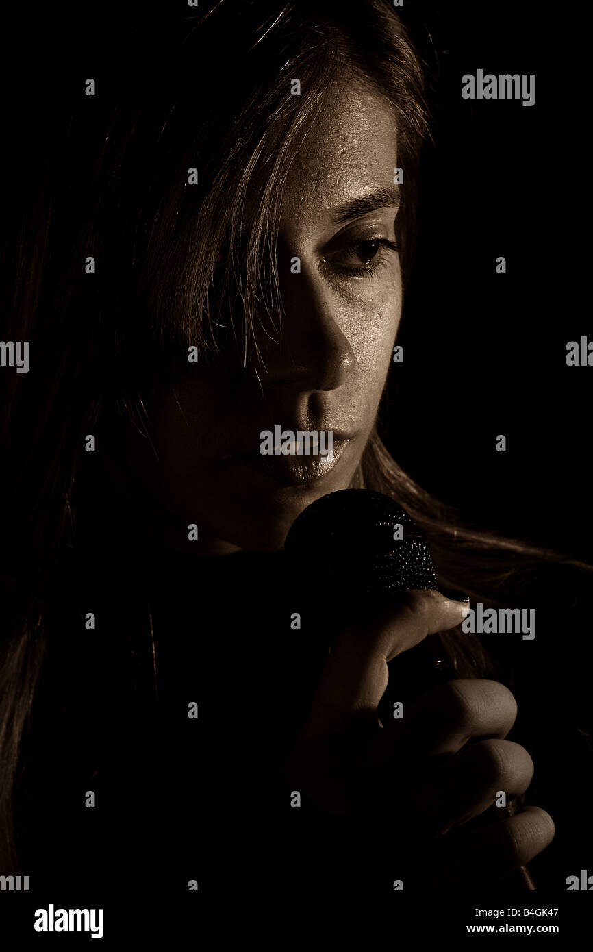 Gothic metal singer, holding a microphone and singing ballads Stock ...