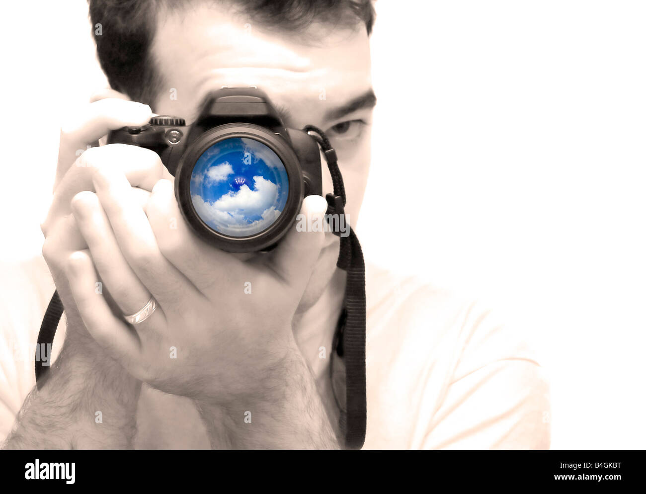 A young photographer taking a shot with his DSLR camera Selective color ...