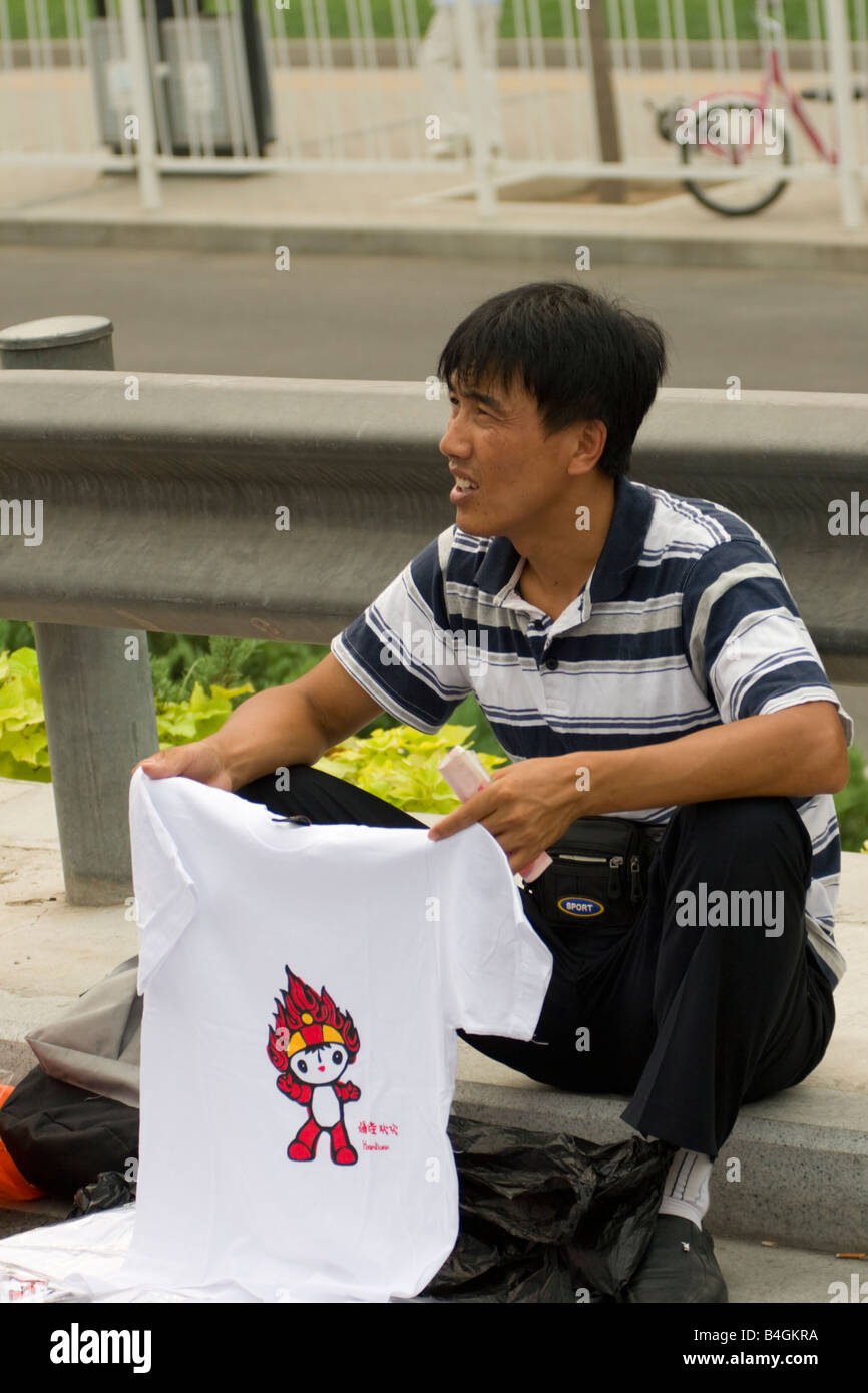 Chinese man selling Olympic mascot tshirts in Beijing , China 2008 ...