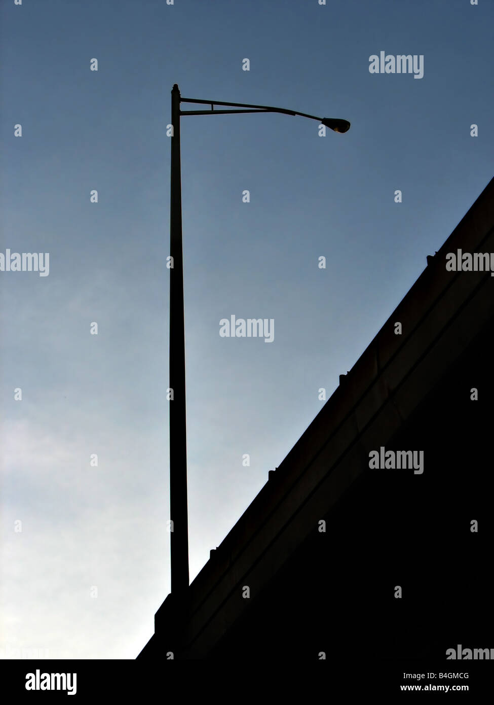 A street lamp as seen from below a highway overpass Stock Photo - Alamy