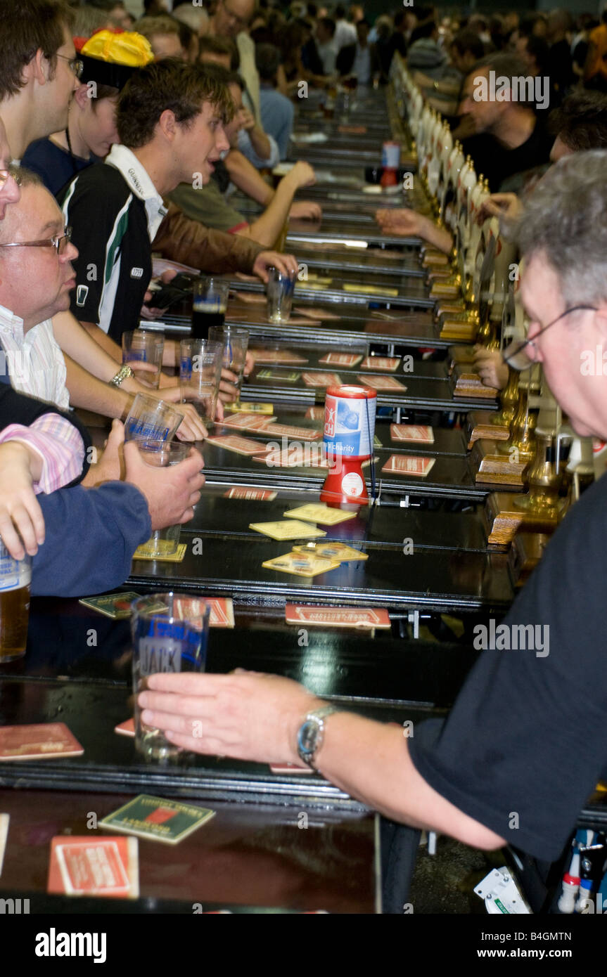 Customers order pints of traditionally made ales at a very long bar at ...