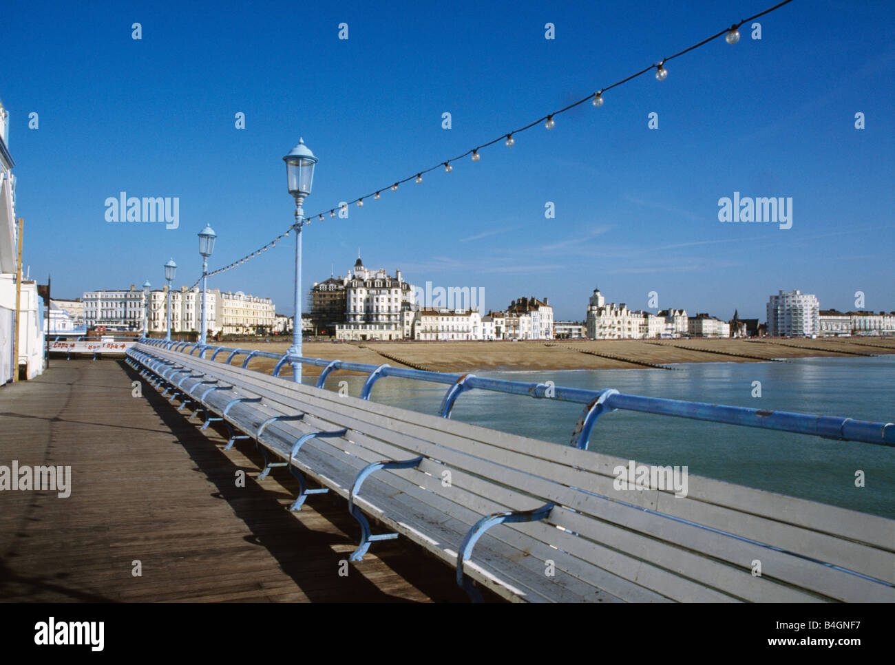 Long bench Victorian seating on the pier at Eastbourne in Sussex Stock ...