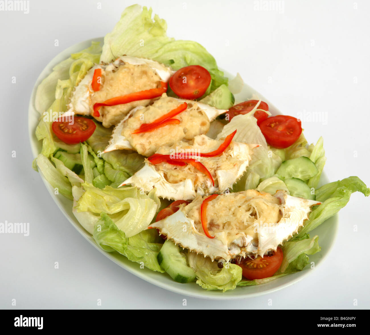 A serving plate with four dressed crabs on a bed of salad Stock Photo ...