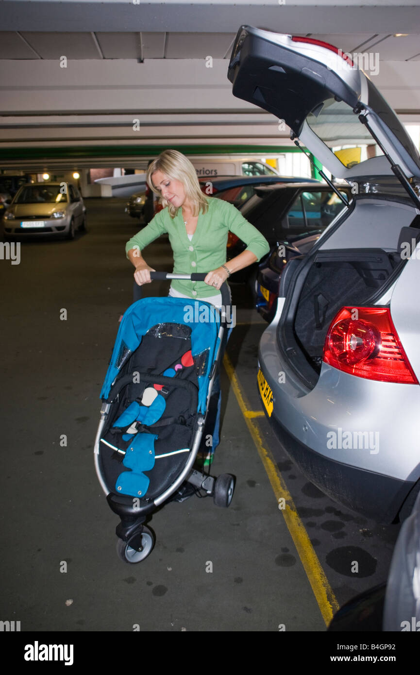 mother getting buggy out of the car in an indoor car park Stock Photo ...