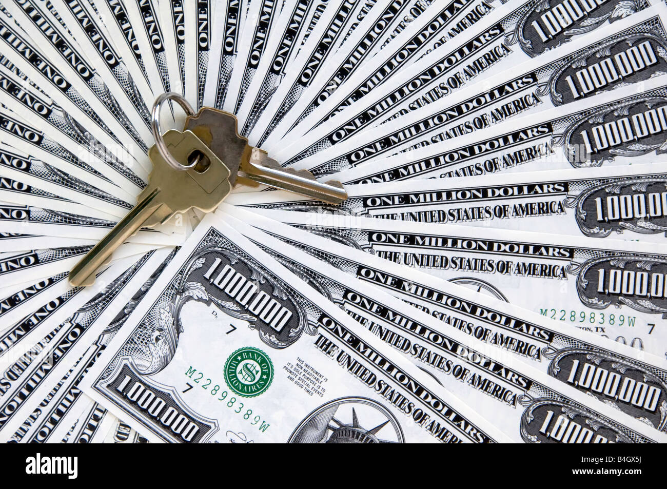 Two keys on millions in cash Stock Photo - Alamy