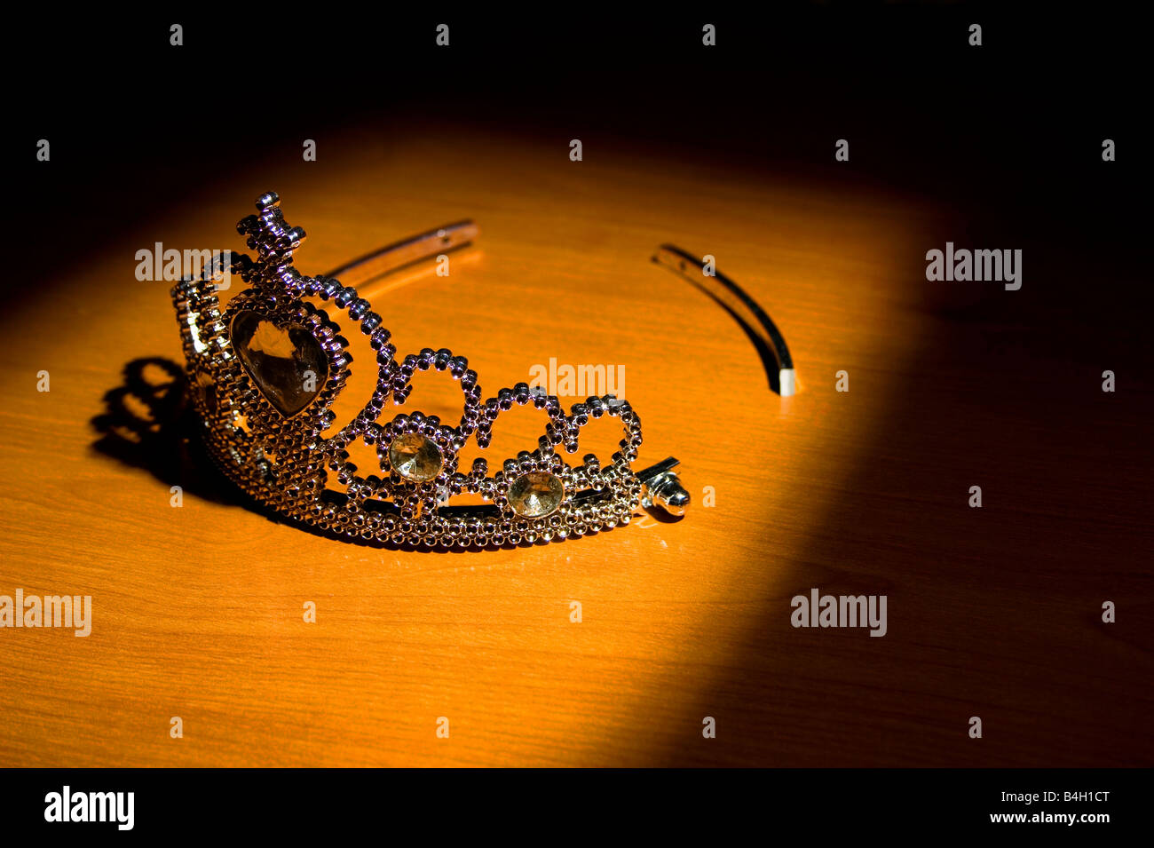 A broken tiara in a rectangular spotlight Stock Photo - Alamy