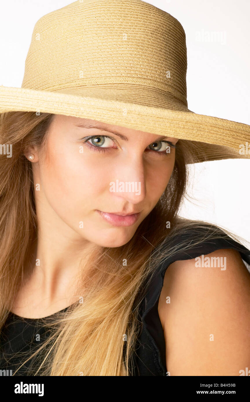 Portrait of woman wearing straw hat Stock Photo - Alamy