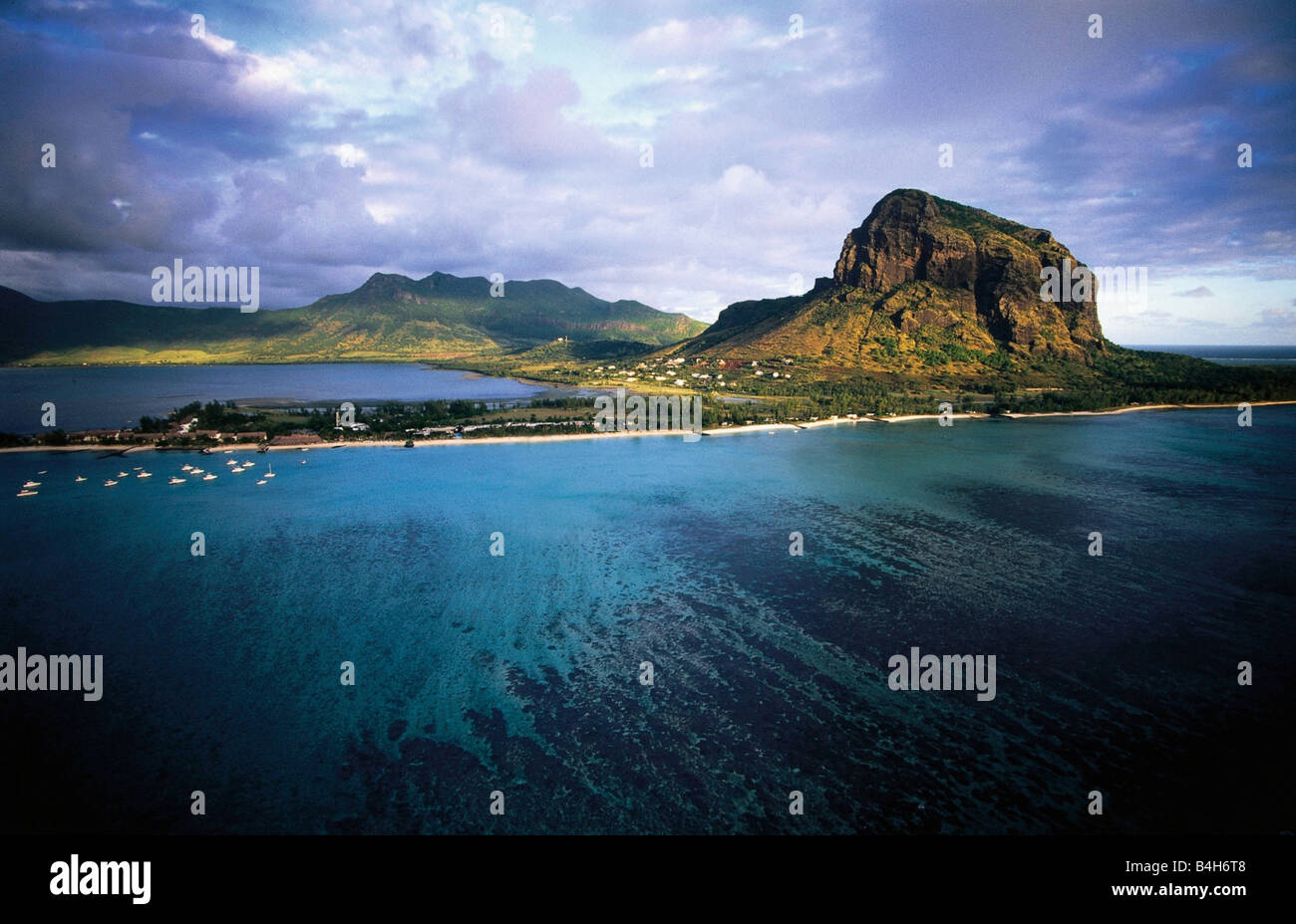 Cliff under clouded sky at the waterfront, Mauritius Stock Photo - Alamy